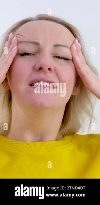 put your hands to your temples stretch your face a woman has headache ...