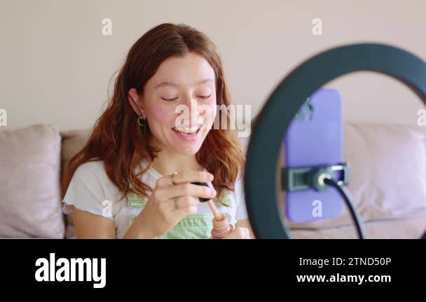 Gen Z influencer guiding makeup tutorial with ring light assistance ...
