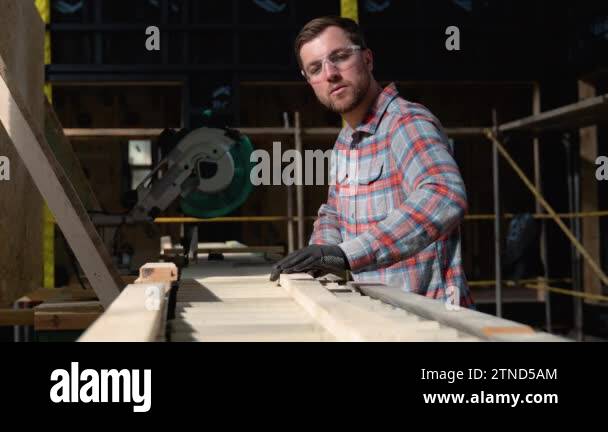 Building contractor worker using hand held worm drive circular saw to ...