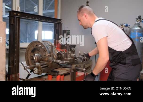 Restoration of a damaged wheel disc in the garage. Car tire repair ...
