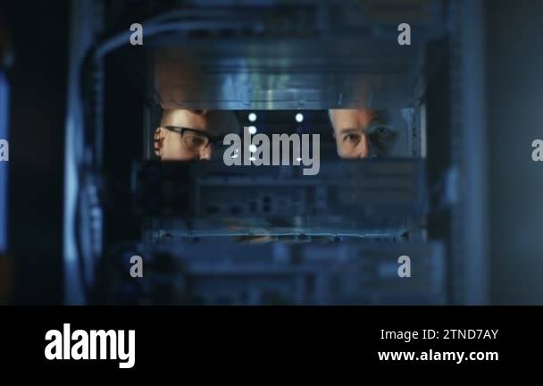 Two Server Engineers Install Hardware in Server Rack. They Work in Big ...