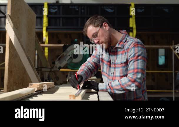 Building contractor worker using hand held worm drive circular saw to ...