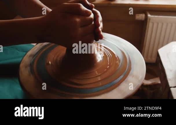 Creating a clay pot.Gonchar.Potter.A turner.Workshop of clay.Clay on the device.Master.Hands ...