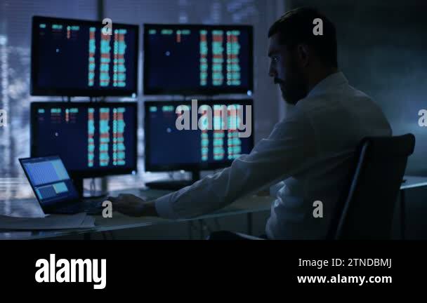 Late at Night Trader Reads Numbers on His Multiple Displays with. He ...