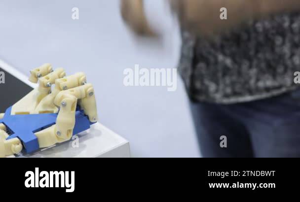 A human and a bionic hands lying beside each other. Cybernetic robot ...