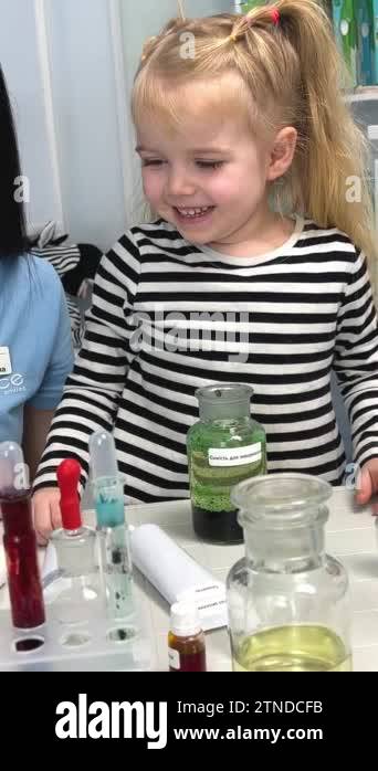 Close-up of colored science test tubes with a blurry background of two ...