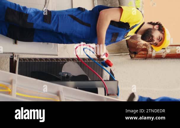 Vertical video Competent mechanic holding electric hand drill stepping ...