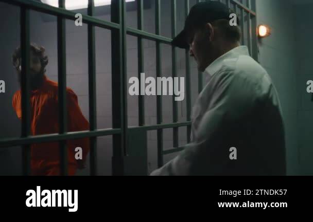 Jailer walks the corridor. Male prisoner hits warden, opens prison cell ...