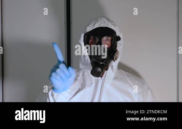 Radiation protection. A man in a chemical suit with a gas mask. Point ...