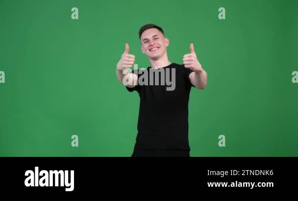 Against a vibrant green background, a Caucasian man enthusiastically ...