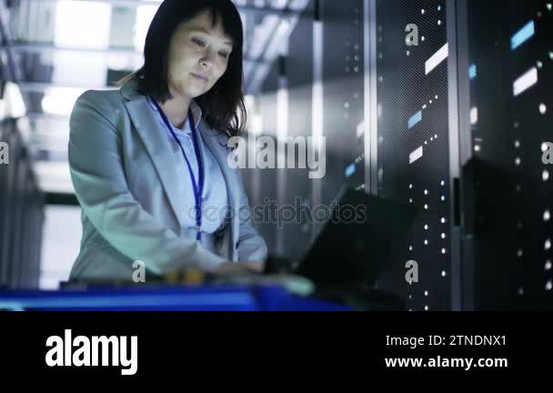 Asian Female IT Engineer Working on a Crash Cart Laptop, She Scans Hard ...