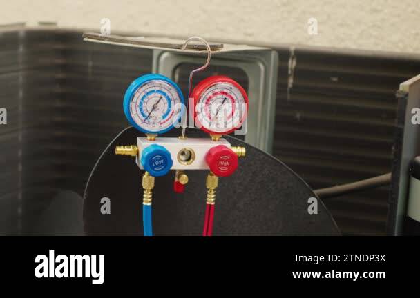 Close up of manifold meters used for checking air conditioner freon in ...