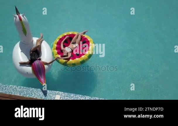 Sexy young girl friend in bikini enjoying summer sun and tanning during ...