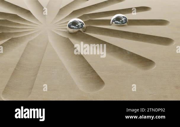 Chrome plated iron balls roll on a Japanese-style wooden pattern. An ...