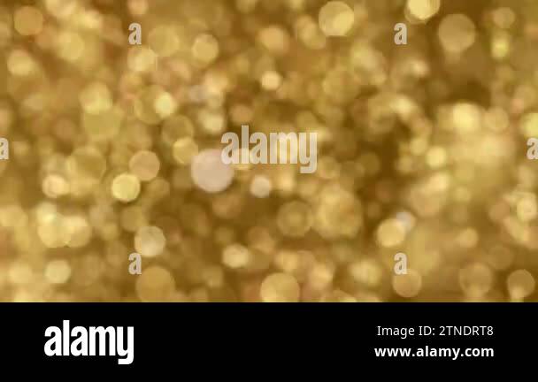 Abstract Christmas background of a blurred bokeh of animated golden flickering light particles ...