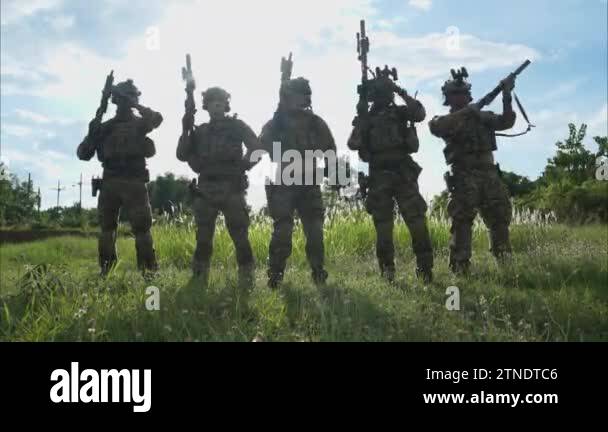 Smart teamwork of soldiers attacking enemy during military operation ...