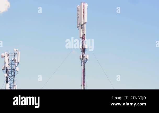 Cell towers against the blue sky and white clouds background ...