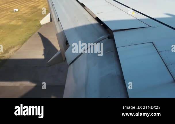 Trip video from an airplane window while landing on an airfield runway ...