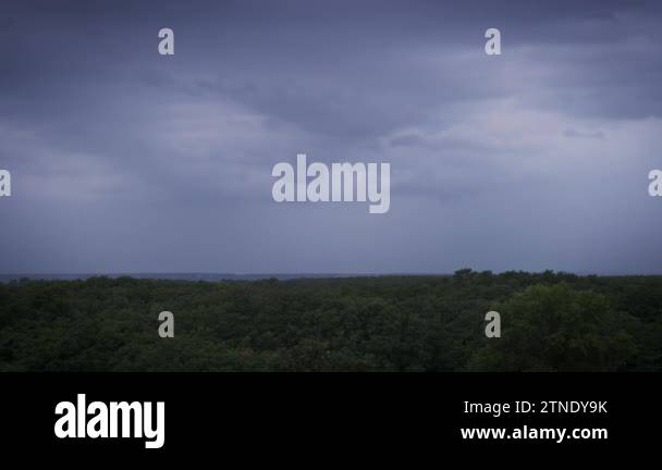 Lightning flash in storm clouds. Heavy clouds bring multiple flashes of ...