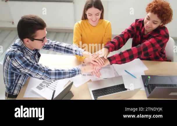 Stack of hands. Business startup teamwork unity concept. Diverse team putting their hands ...