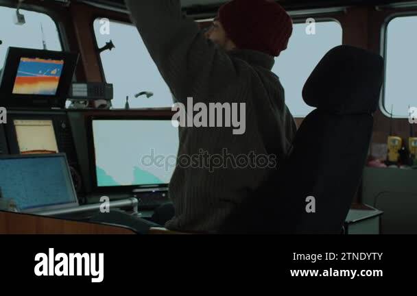 Captain of Commercial Fishing Ship Surrounded by Monitors and Screens ...
