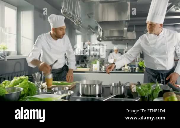 Two Famous Chefs Work as a Team in a Big Restaurant Kitchen. Vegetables ...
