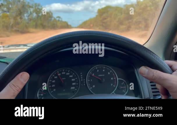 POV (point of view of a person) driver holding steering wheel while ...