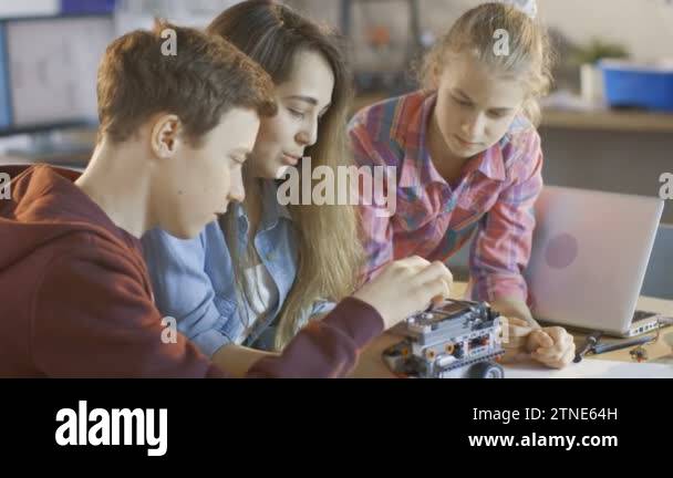 Two Girls and a Boy Program Robot for School Science Class Project ...
