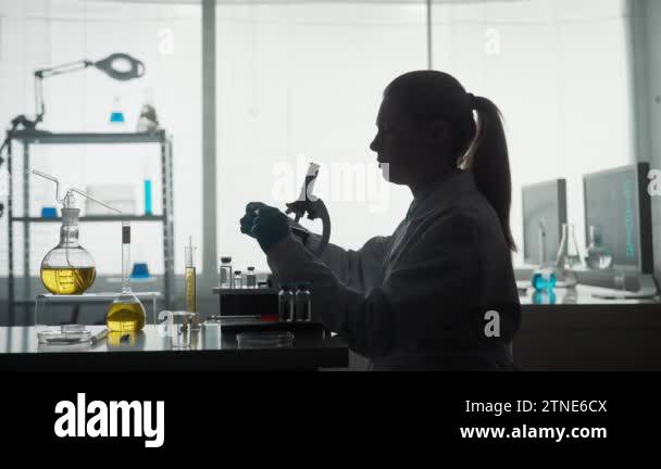 Medical scientific laboratory. Side view of a dark silhouette of a ...