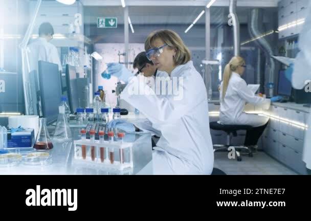 High Tech Ultra Modern Laboratory with Scientists Conducting ...
