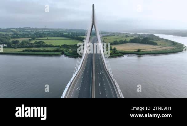 Two cars drive across the bridge towards the camera. Cable-stayed ...