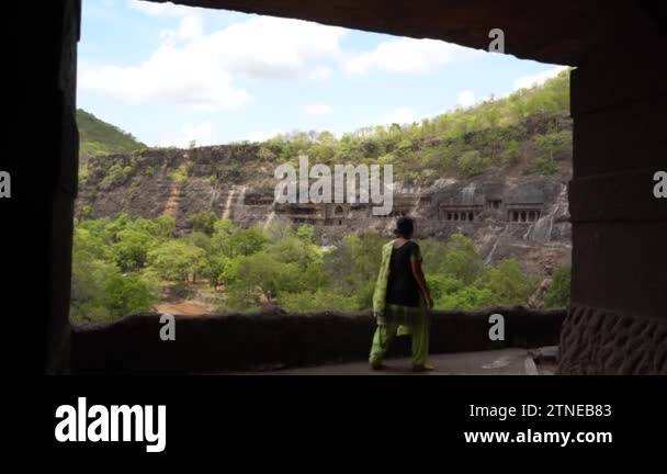 Woman tourist visit to the Ajanta caves and exploring the ancient ...