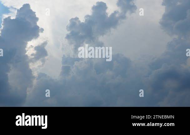 Beautiful clouds in the sky. Volumetric light effect. The sunrays are hidden behind the ...