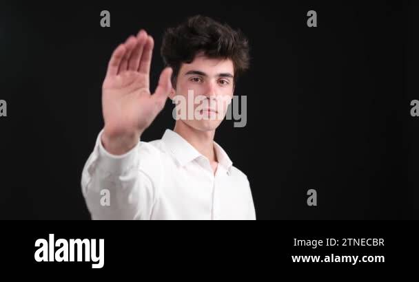 Stern and commanding Caucasian man standing on striking black ...