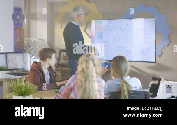 Teacher Explains Lesson To His Computer Science Class. He uses Interactive Whiteboard Stock ...