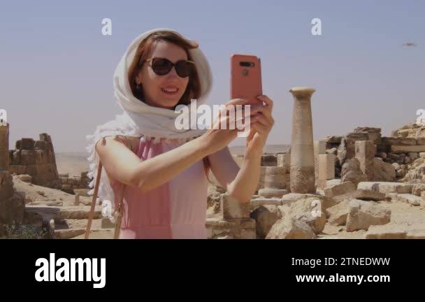 Woman in a dress is taking a selfie in Egypt. The Great Pyramids of ...