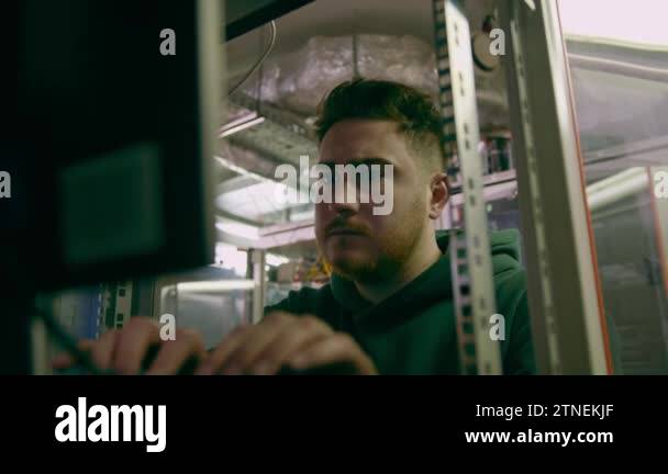 focused hacker data center hacking software system vulnerable cyber security server room ...