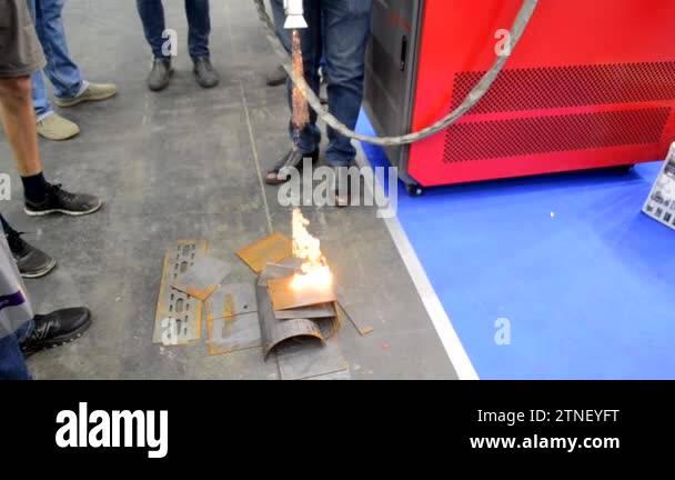 Process of laser cleaning of metal surfaces. Man cleaning surface from ...