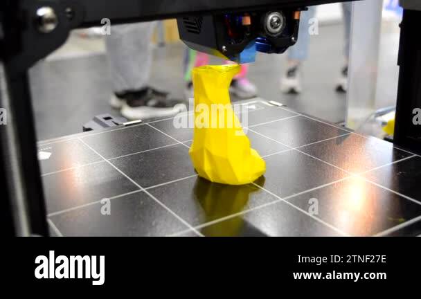 Working 3D printer printing an object from plastic. Printing a model from molten plastic using a ...