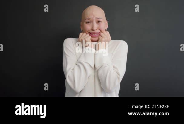 Young scared woman covering face with hands. Can not speak over ...