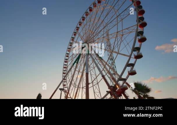 Brightly lit Ferris wheel in Georgia's Tsitsinatela amusement park ...