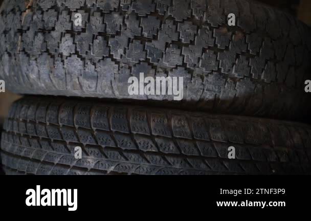 Two old car tires with different tire patterns. The difference between ...
