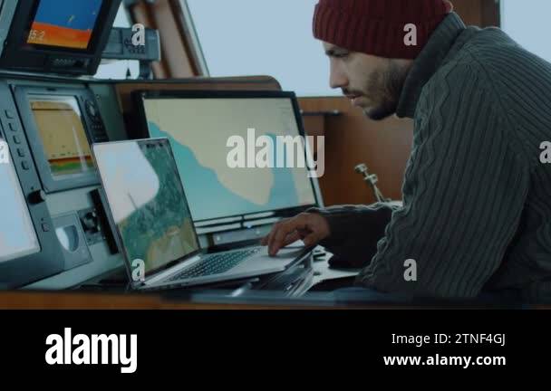 Captain of Commercial Fishing Ship Surrounded by Monitors and Screens ...