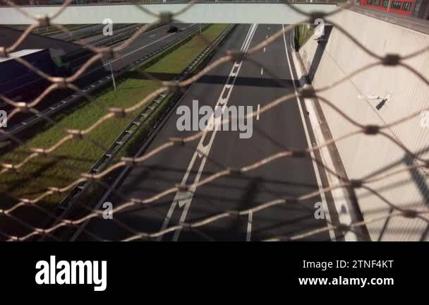 Panning shot down from overpass on truck, tour bus and car traffic on ...