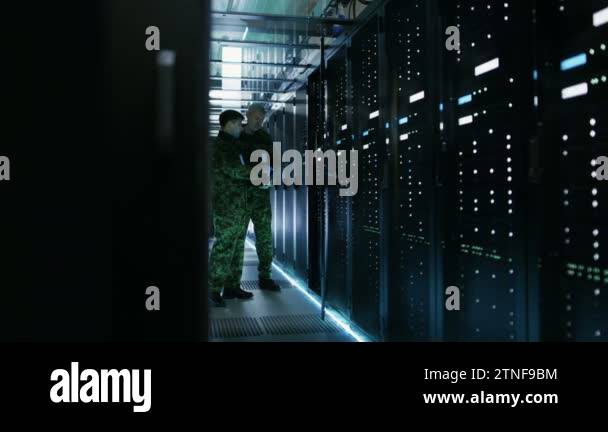 In Data Center Two Military Men Work with Open Server Rack Cabinet. One ...
