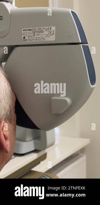 ophthalmologist checks the eyesight using modern vision tester man ...