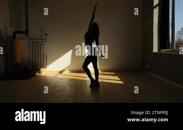 The horizontal side view of the woman moving legs and raising hands up ...