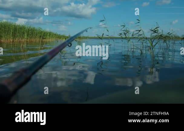 the Fisherman Sits in the Boat, Filmed in Close-Up Spinning, Rod, Amid ...