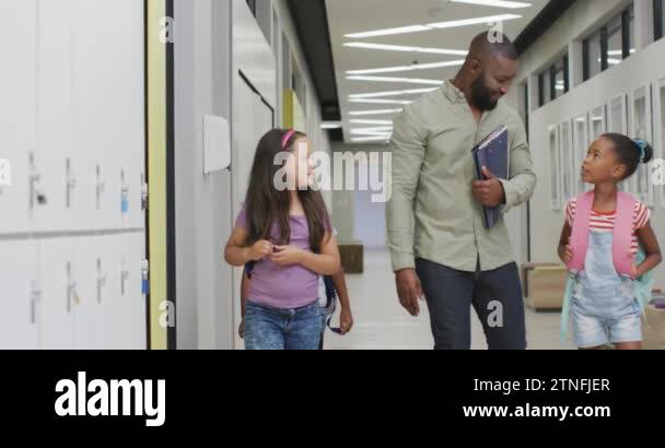 Animation of back 2 school text over happy diverse male teacher and ...