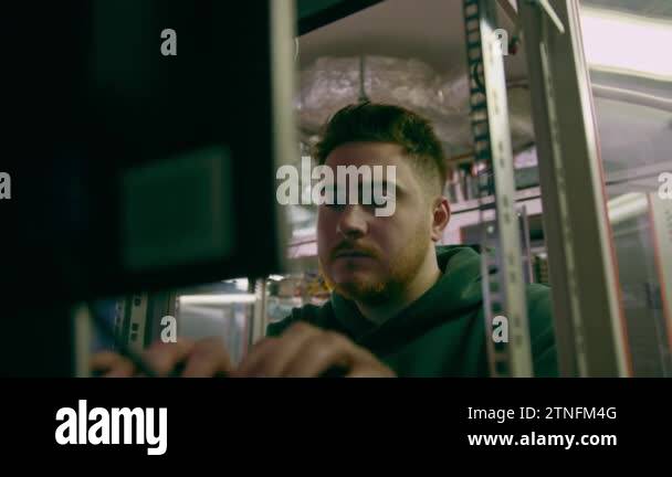 focused hacker data center hacking software system vulnerable cyber security server room ...